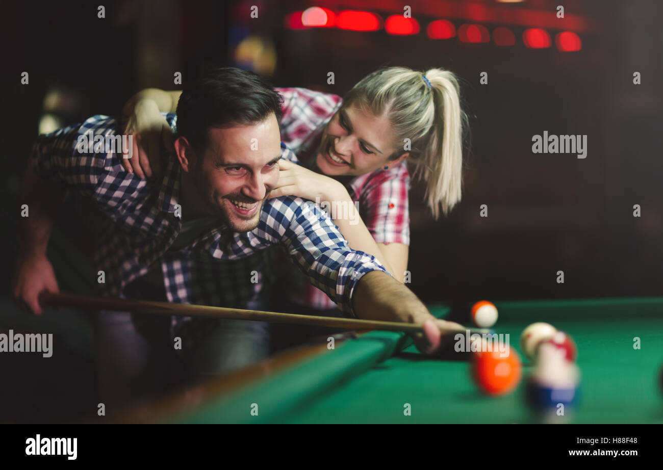 Couple dating and having fun playing snooker Stock Photo - Alamy