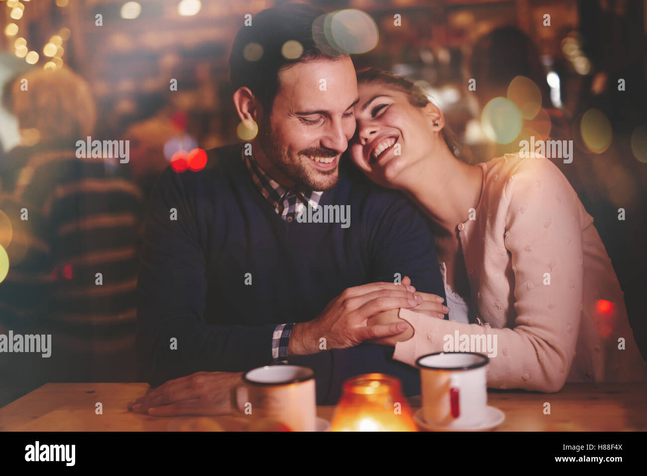 Romantic couple dating in pub at night Stock Photo - Alamy