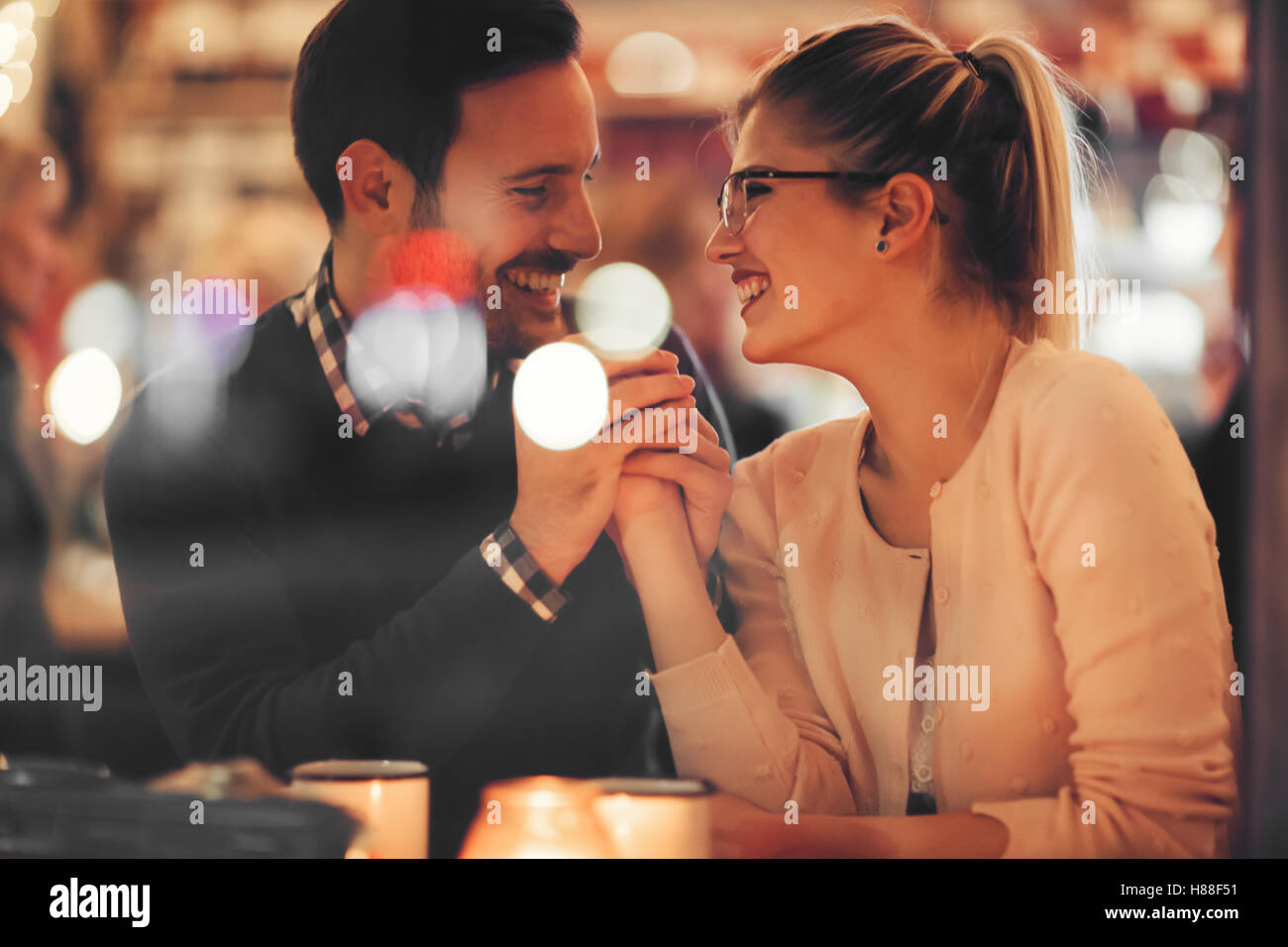 Romantic couple dating at night in pub Stock Photo - Alamy