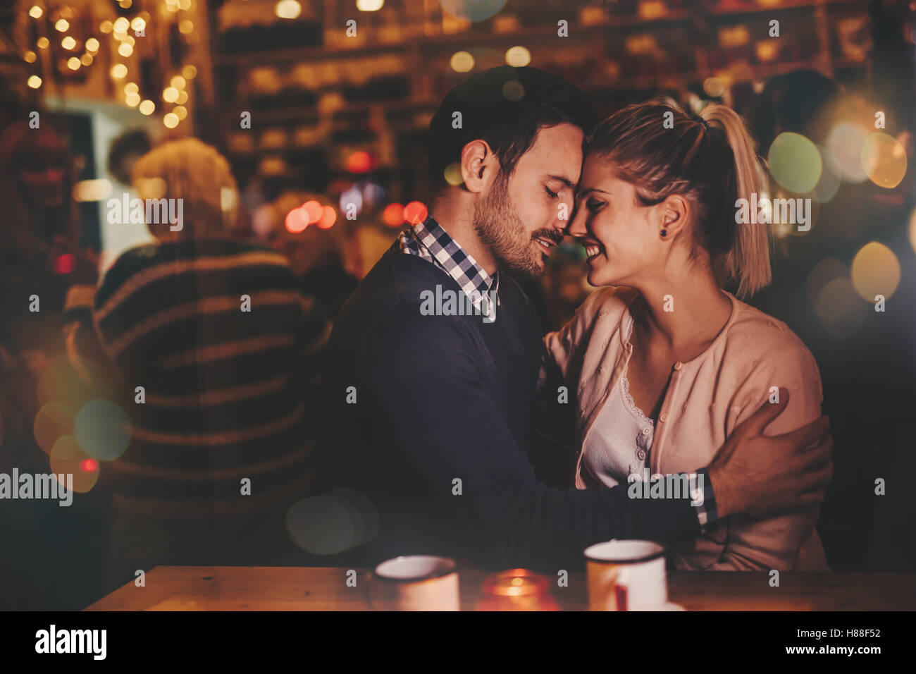 Romantic couple dating at night in pub Stock Photo - Alamy