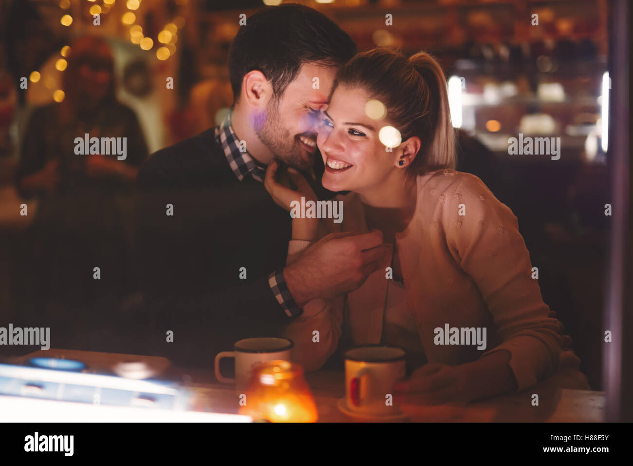 Romantic couple dating at night in pub Stock Photo - Alamy