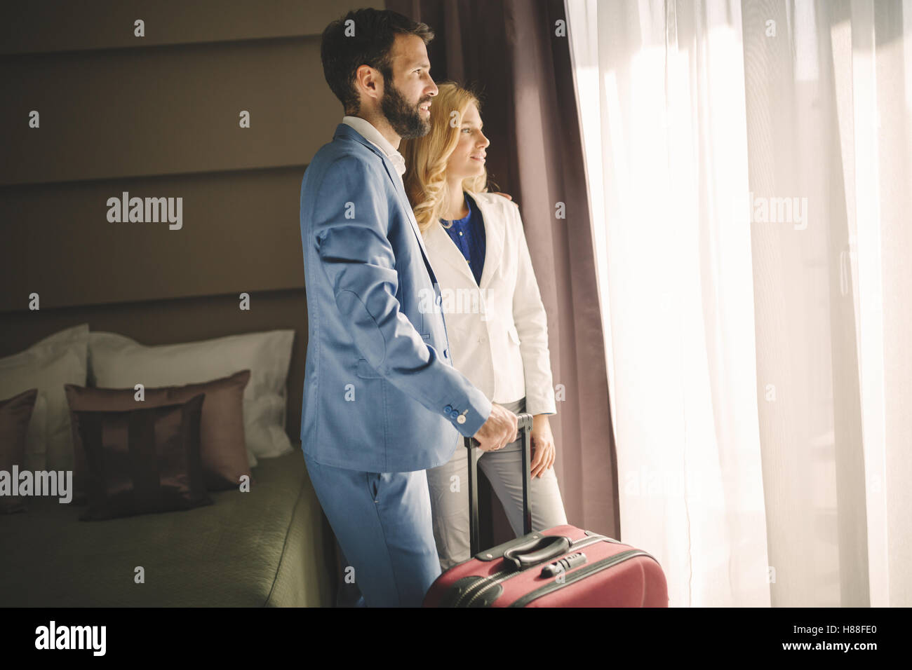 Business couple in formal wear in hotel room Stock Photo - Alamy