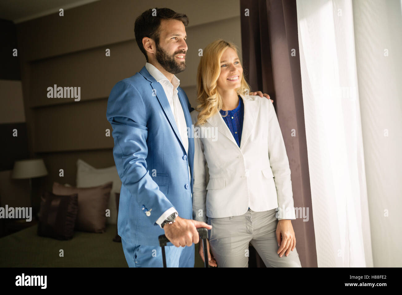 Business couple in formal wear in hotel room Stock Photo - Alamy