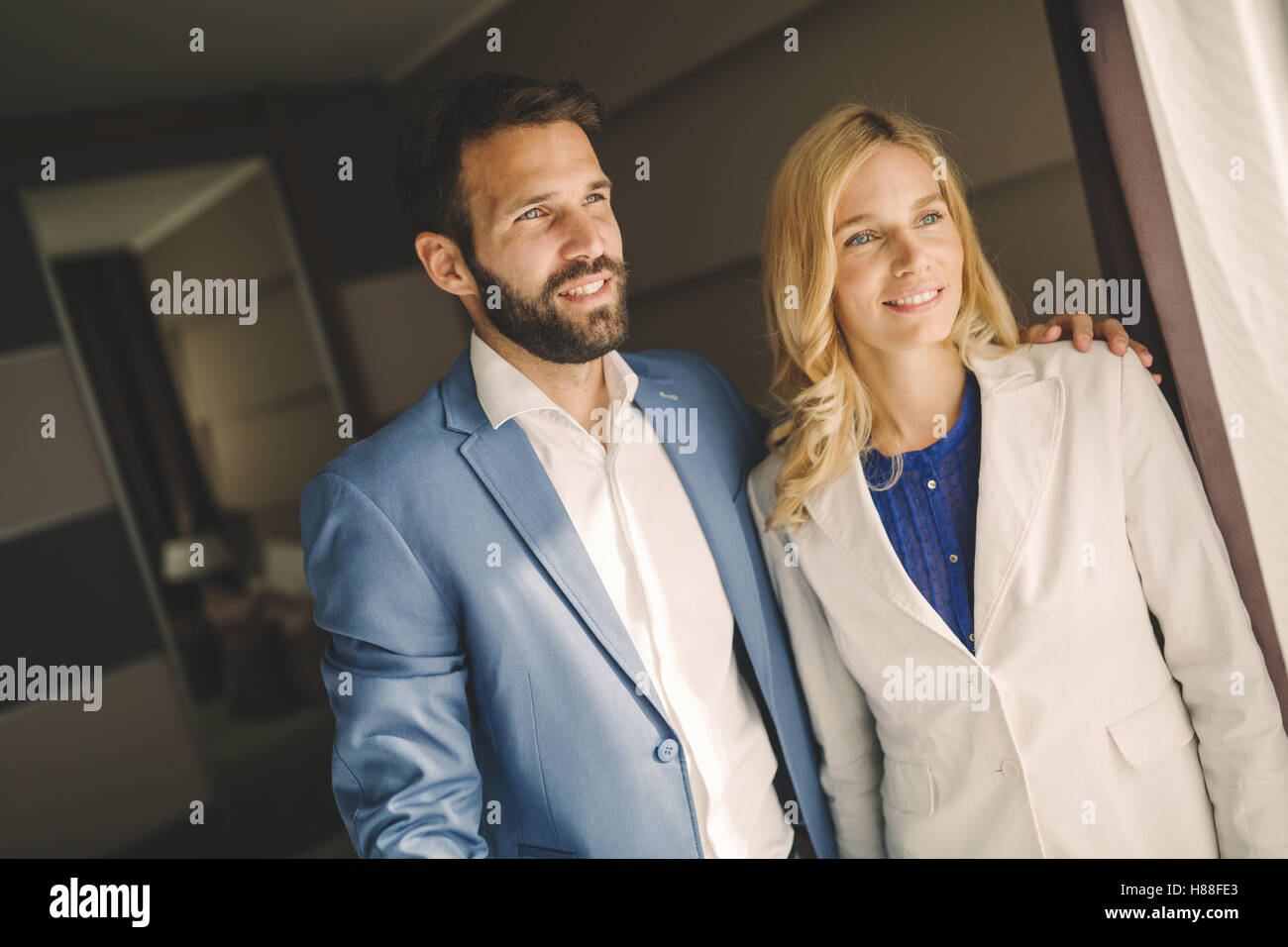 Business couple in formal wear in hotel room Stock Photo - Alamy