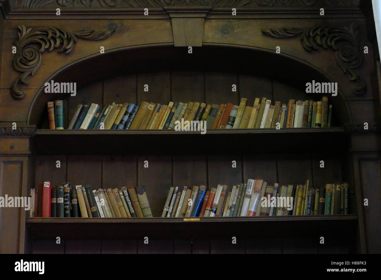 Wooden book shelves with old library books Stock Photo - Alamy