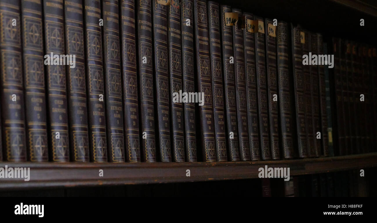 Wooden book shelves with old library books Stock Photo - Alamy