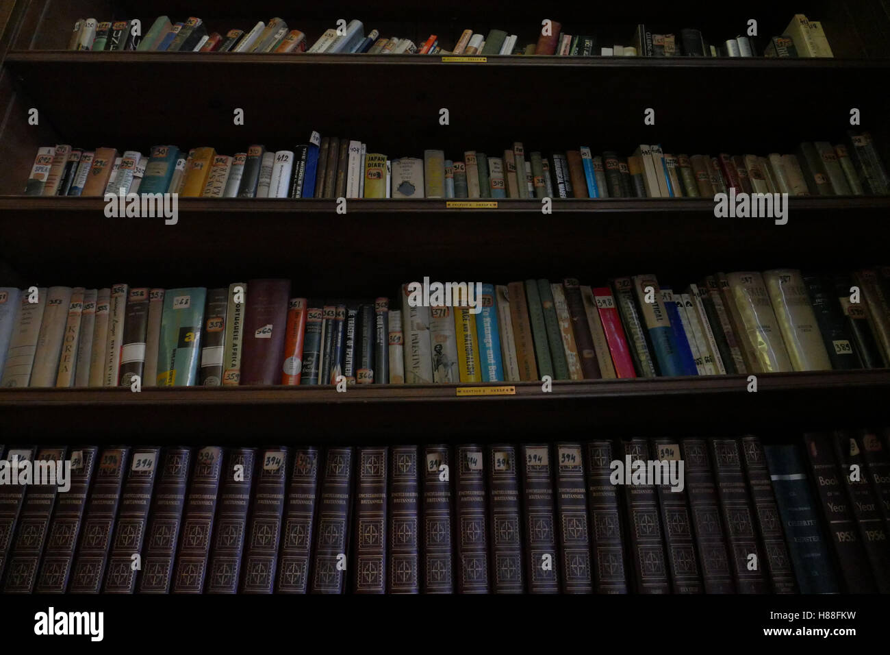 Wooden book shelves with old library books Stock Photo - Alamy