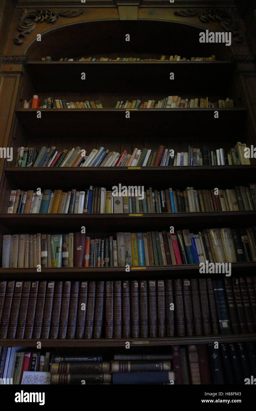 Wooden book shelves with old library books Stock Photo - Alamy
