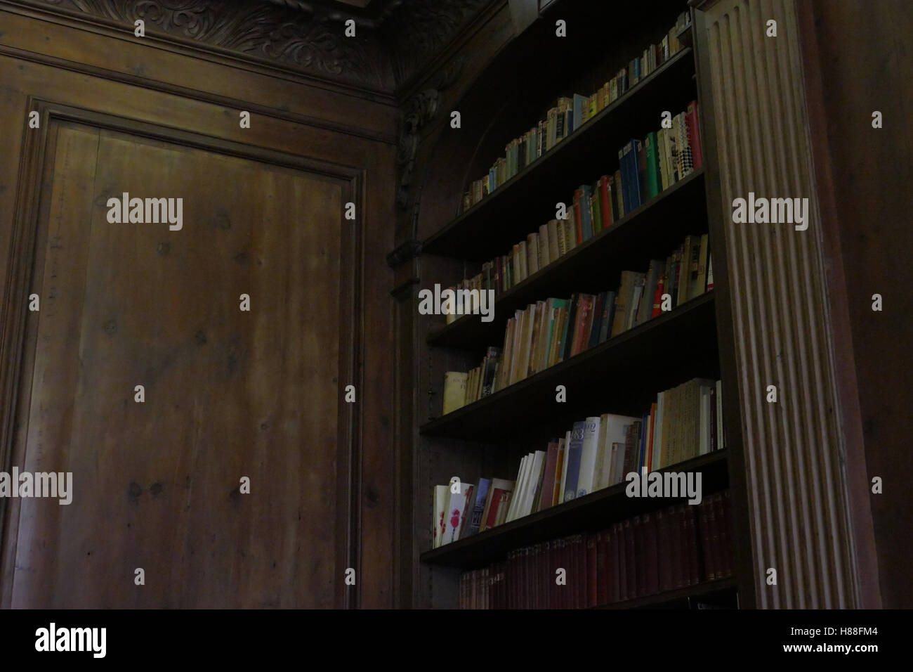 Wooden book shelves with old library books Stock Photo - Alamy