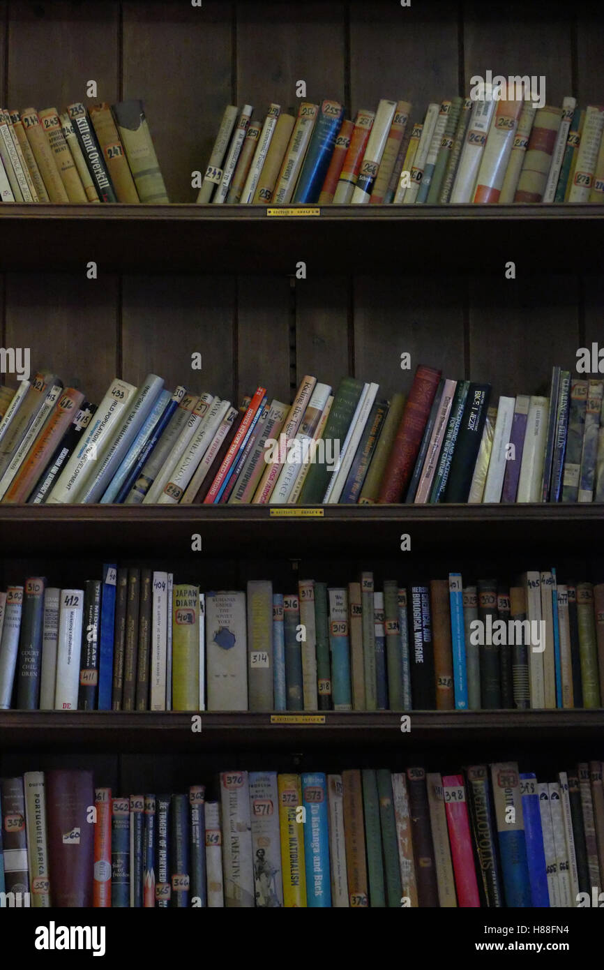 Wooden book shelves with old library books Stock Photo - Alamy
