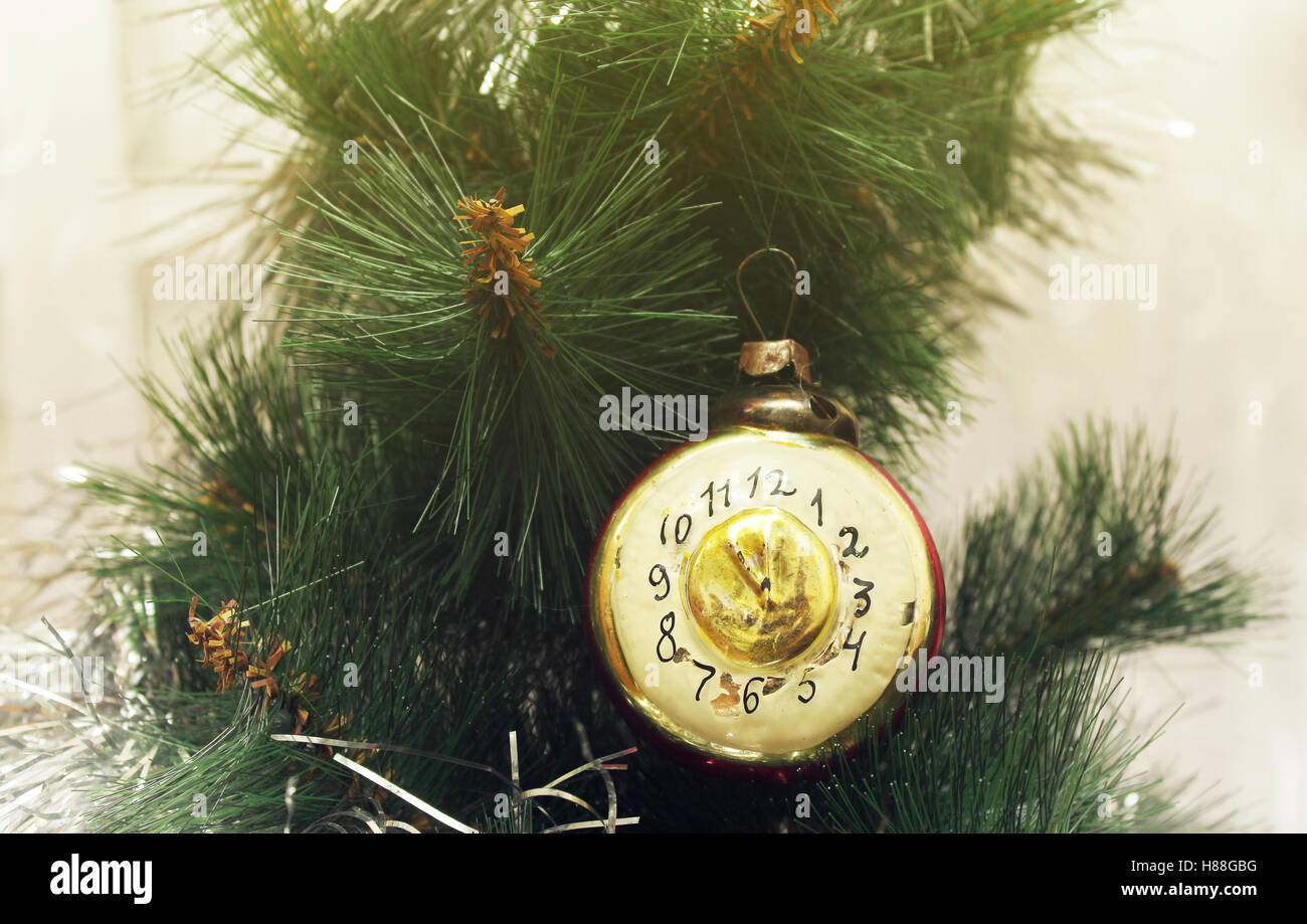 Toy "clock" on the Christmas tree Stock Photo - Alamy