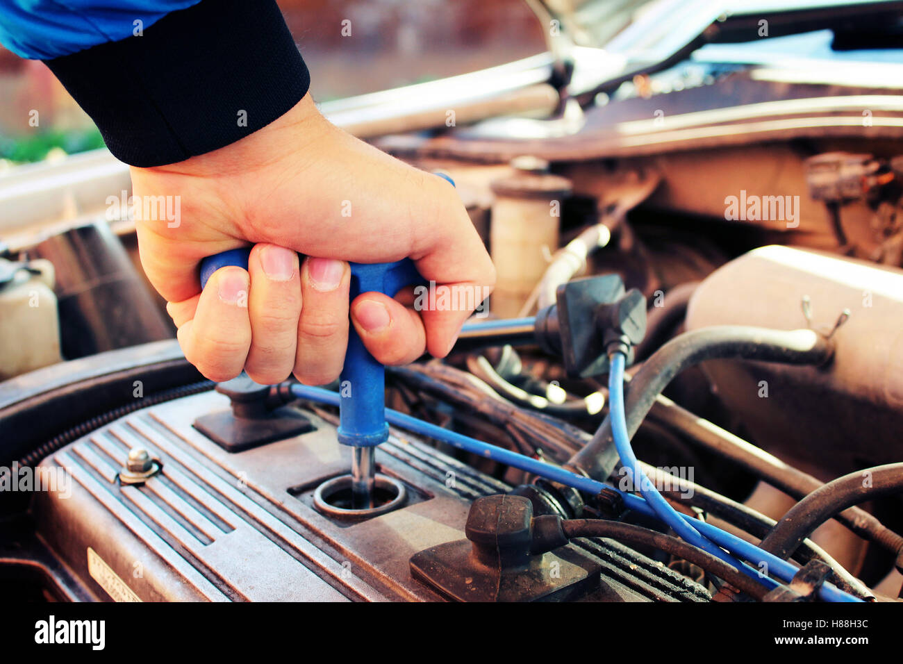 Hand with wrench for spark plugs Stock Photo - Alamy