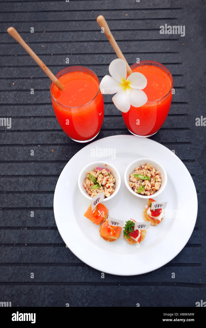 Two glasses of orange juice with snack on a smiley face Stock Photo - Alamy