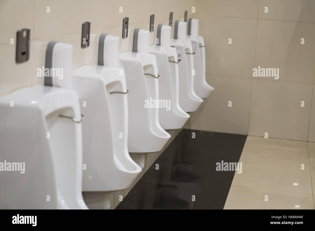 New row of outdoor urinals men public toilet Stock Photo - Alamy