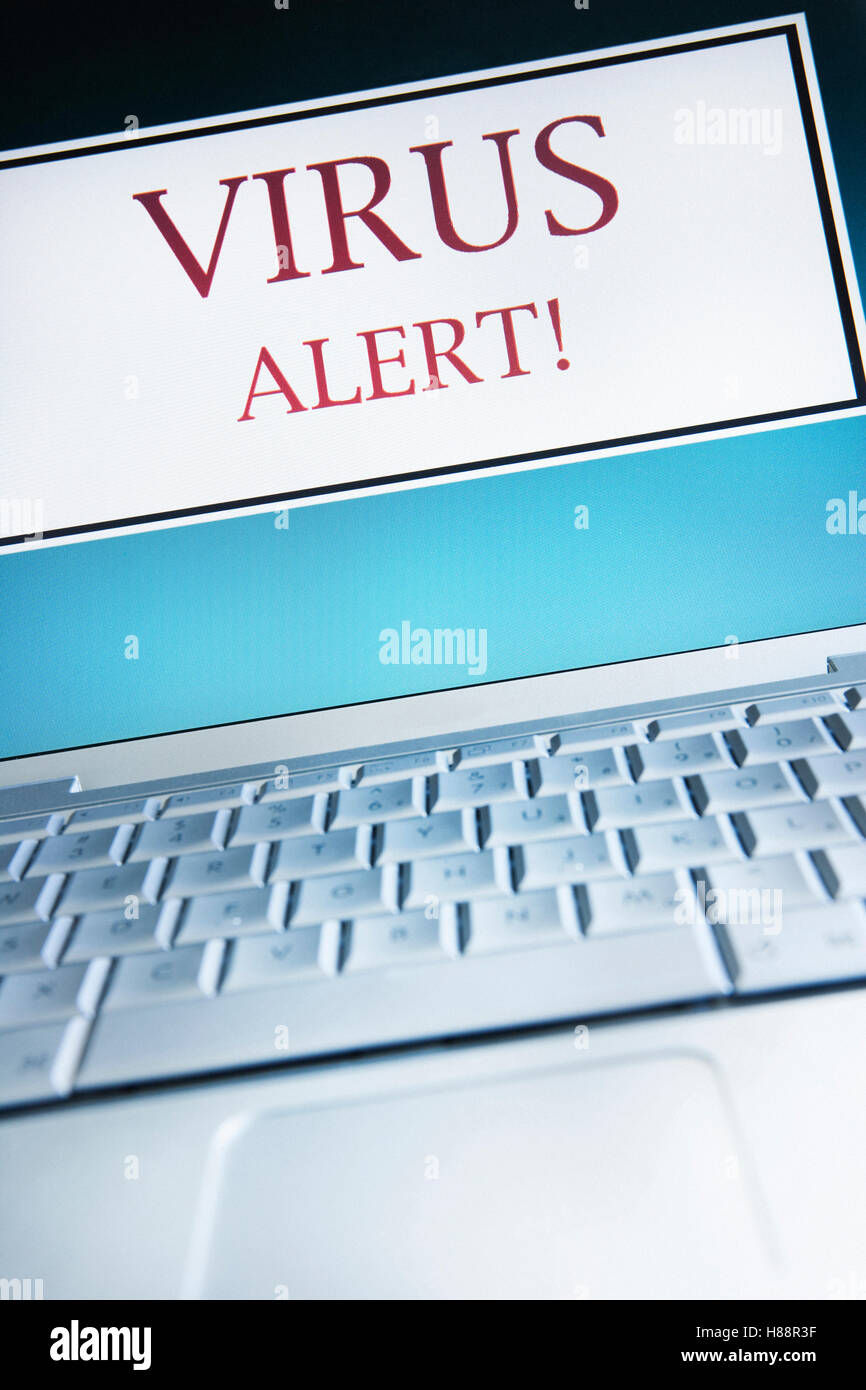 Virus alert sign on laptop screen Stock Photo - Alamy
