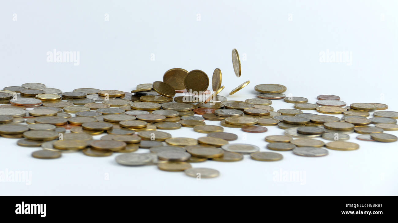 Coins fall into a pile Stock Photo - Alamy