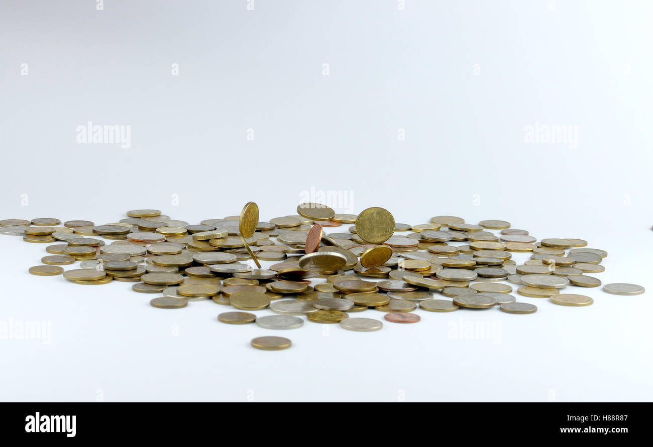 Coins fall into a pile Stock Photo - Alamy