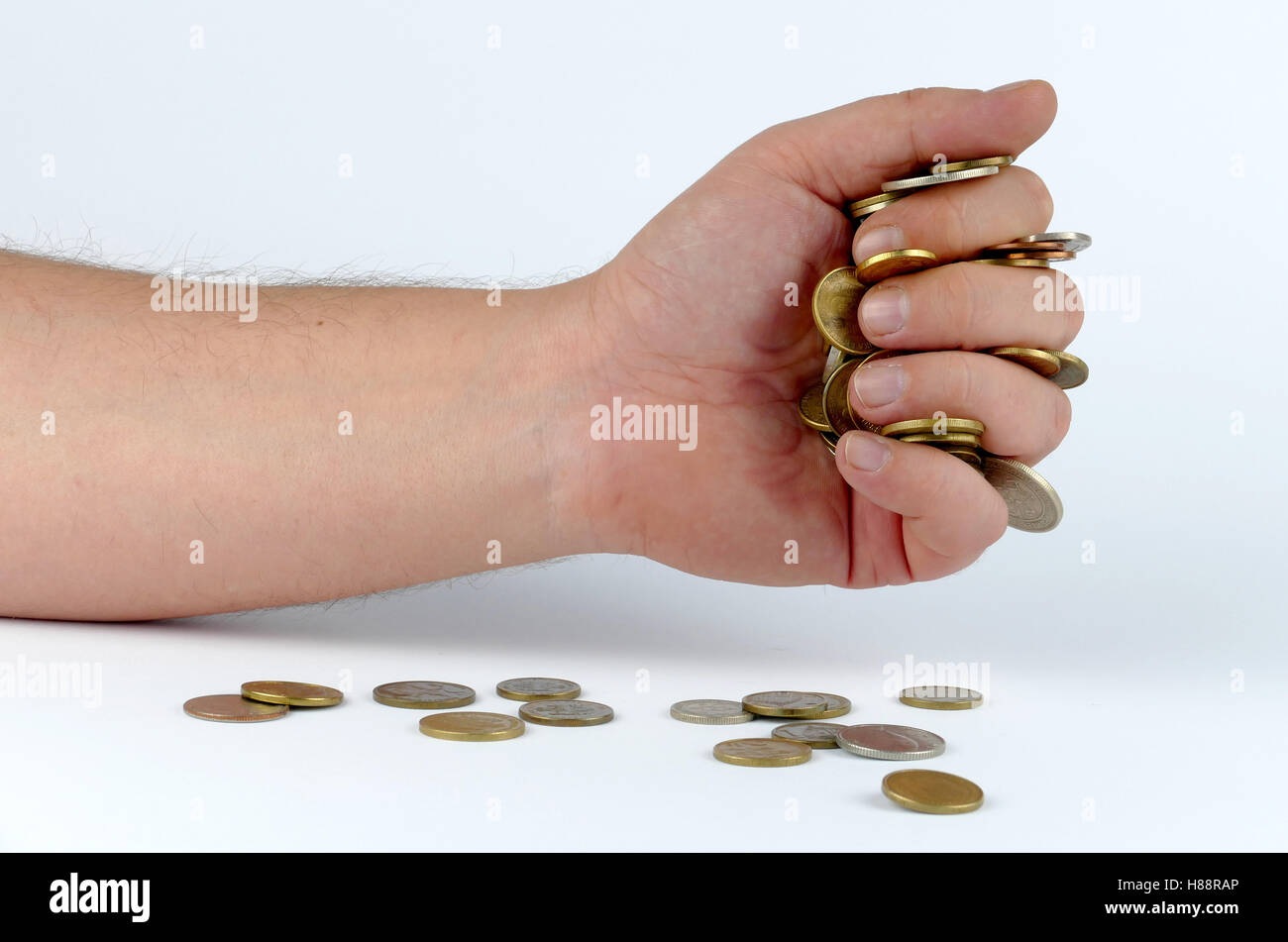 Handful of coins Stock Photo - Alamy
