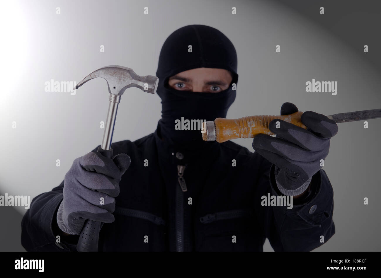 Burglar holding burglary tools Stock Photo - Alamy
