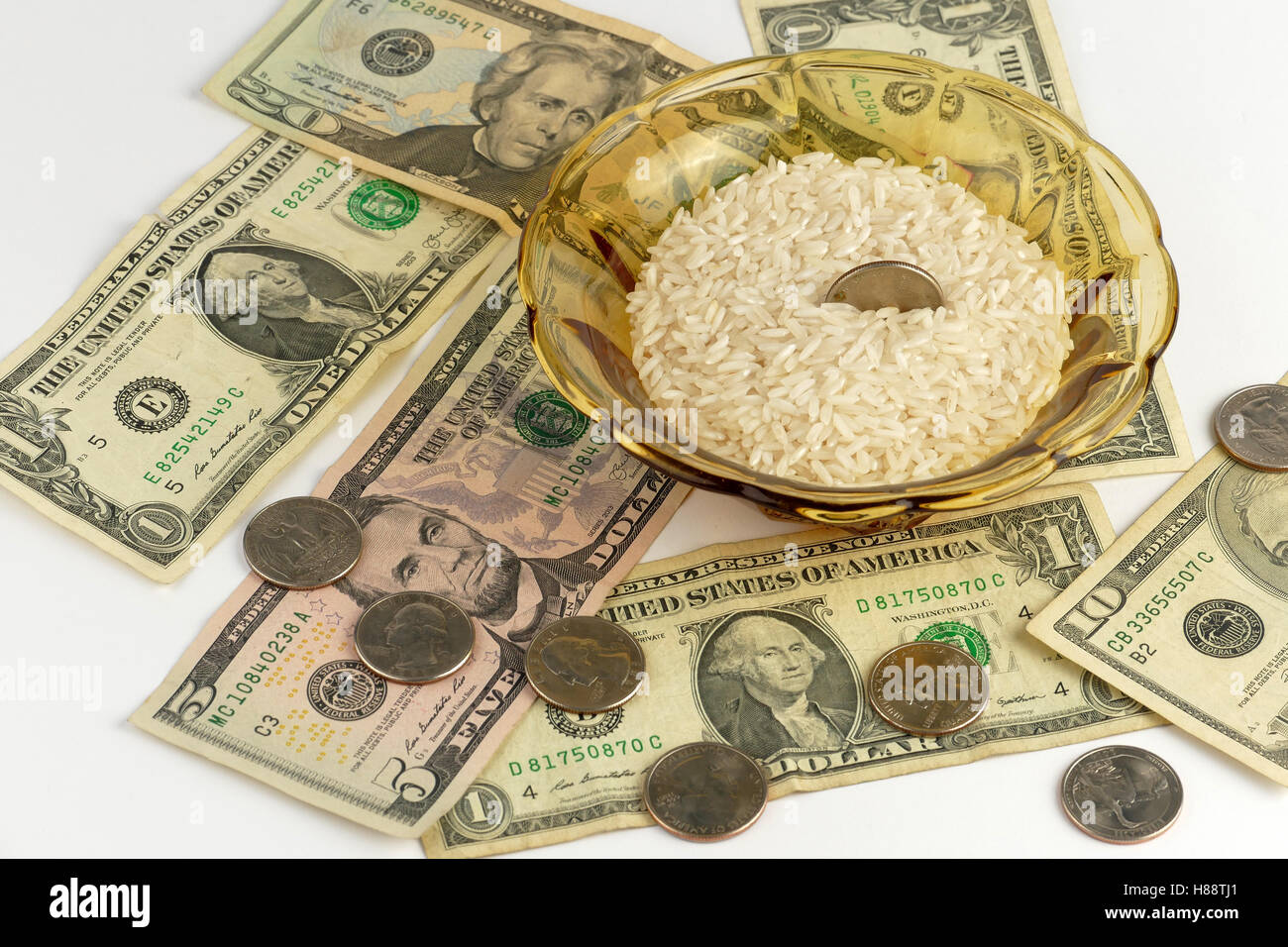 Rice and Money isolated on white background Stock Photo - Alamy