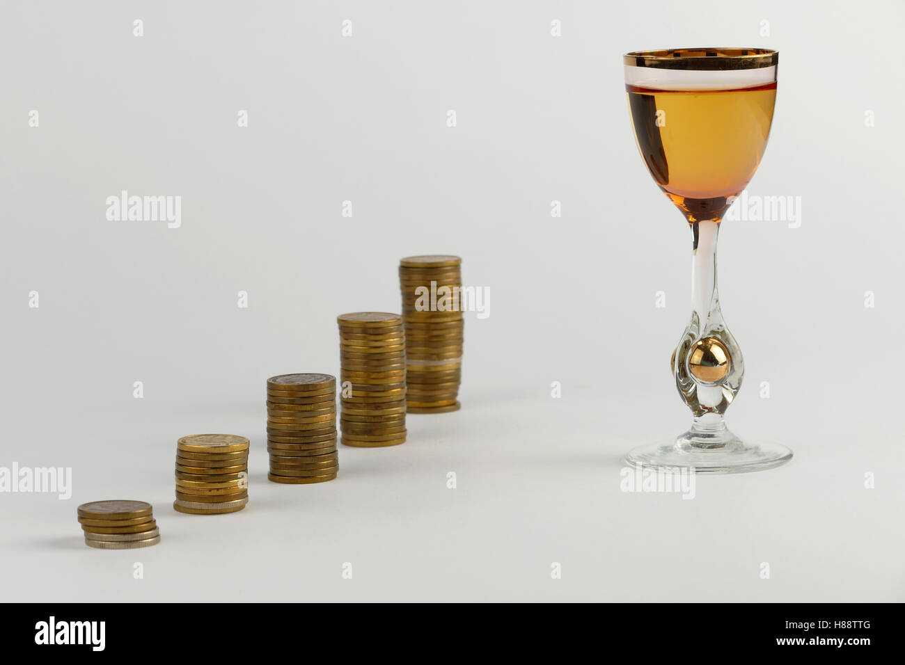 Glass of alcohol drink with money isolated on white background Stock ...