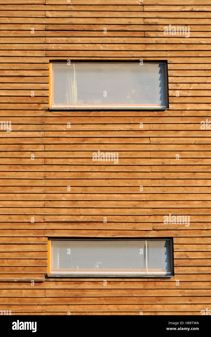 Windows on wooden facade of the low-energy sustainable building of ...