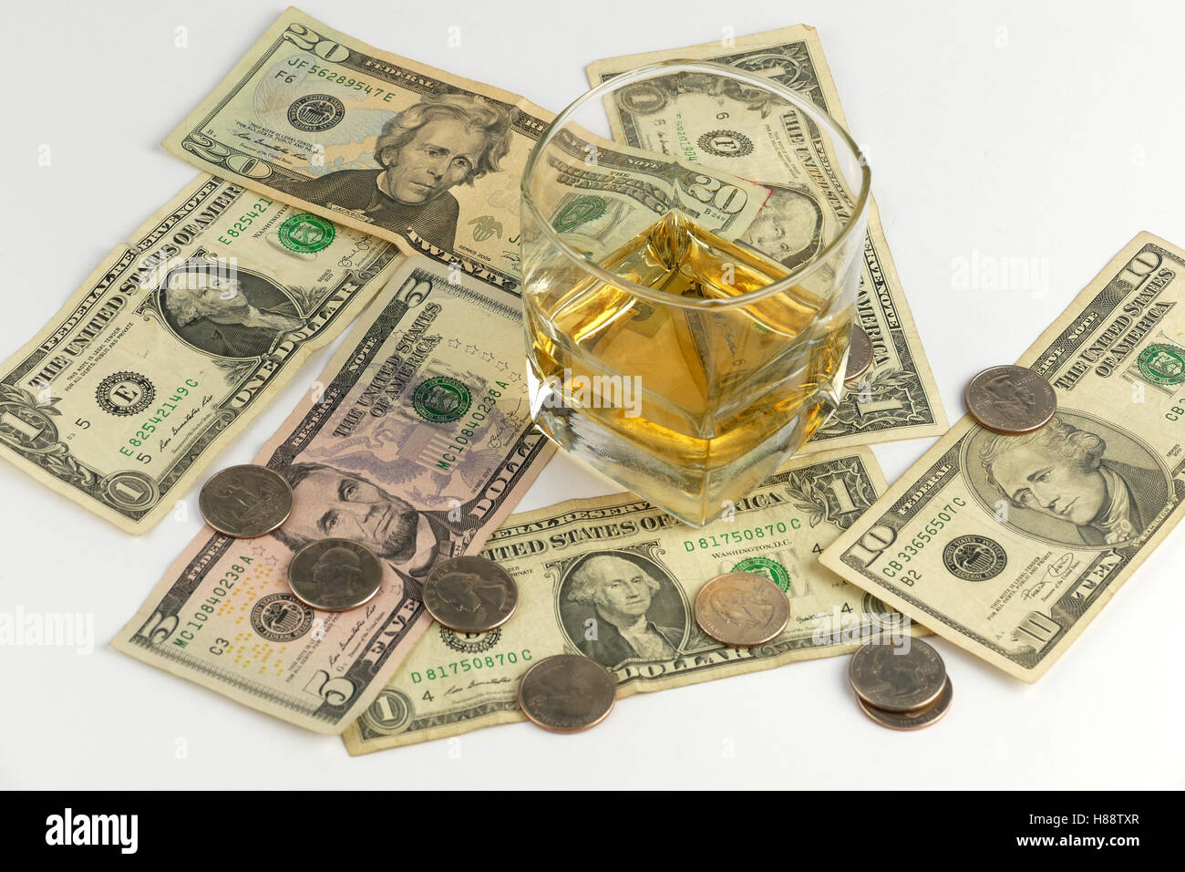 Glass of alcohol drink with money isolated on white background Stock ...