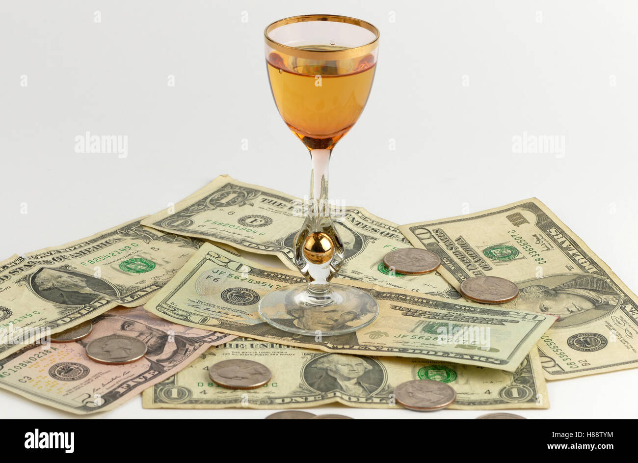 Glass of alcohol drink with money isolated on white background Stock ...