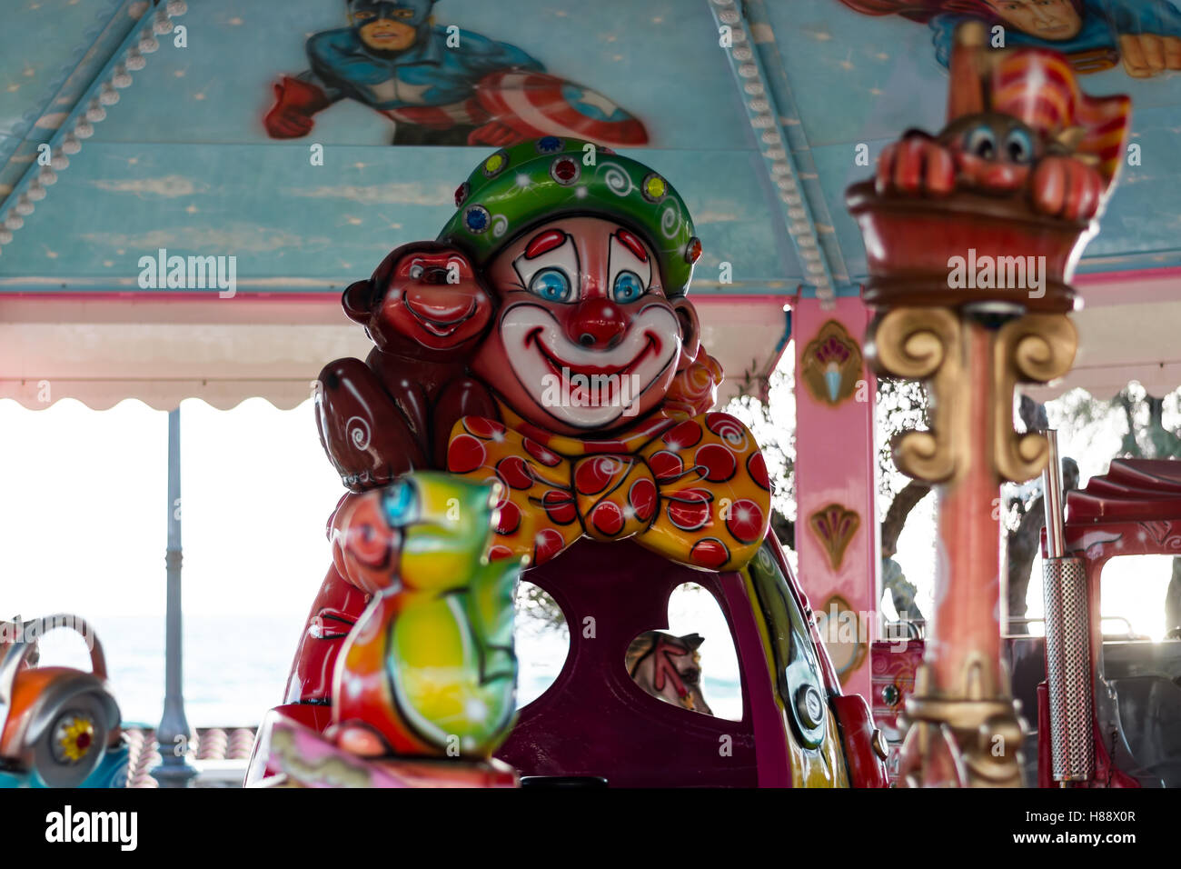 Vintage carousel clown sunny day Stock Photo - Alamy