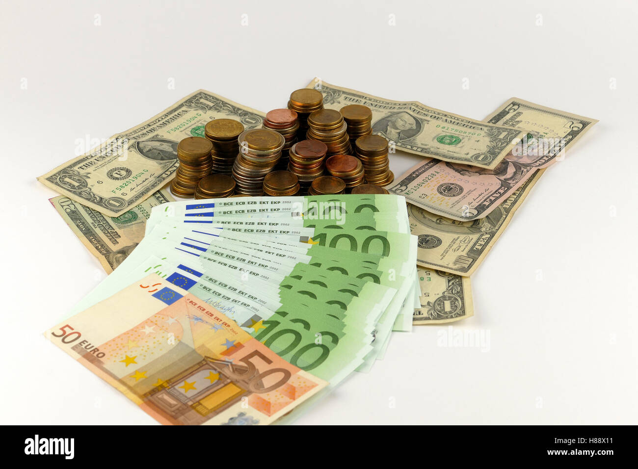 Banknotes and coins isolated on white background Stock Photo - Alamy