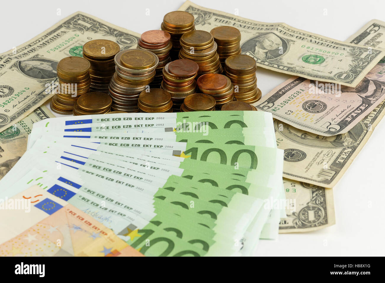 Banknotes and coins isolated on white background Stock Photo - Alamy