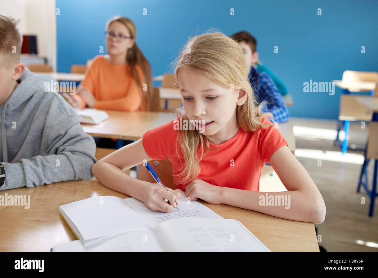 student girl with book writing school test Stock Photo - Alamy