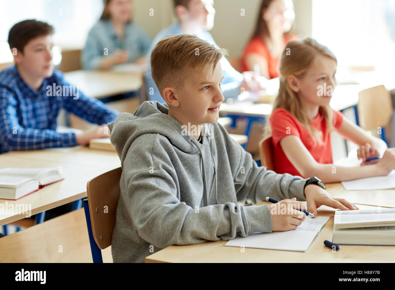 group of students with notebooks at school lesson Stock Photo - Alamy