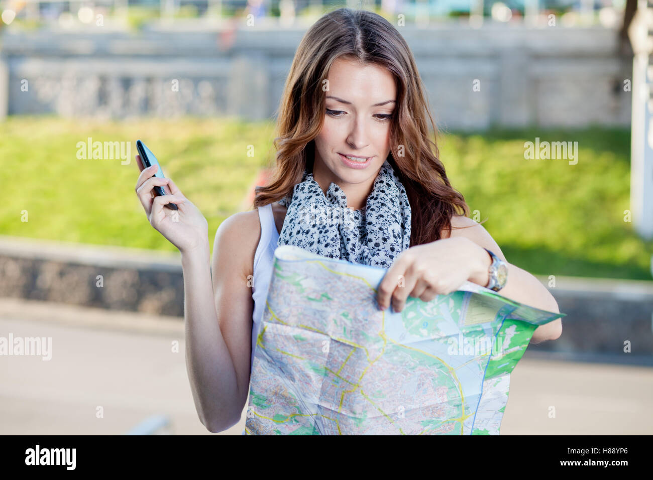 young woman tourist holding paper map Stock Photo - Alamy