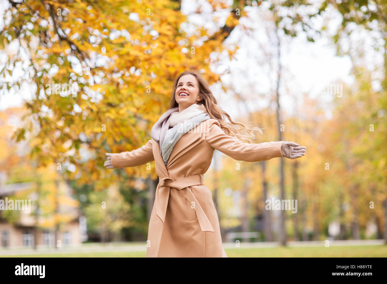 beautiful happy young woman walking in autumn park Stock Photo - Alamy
