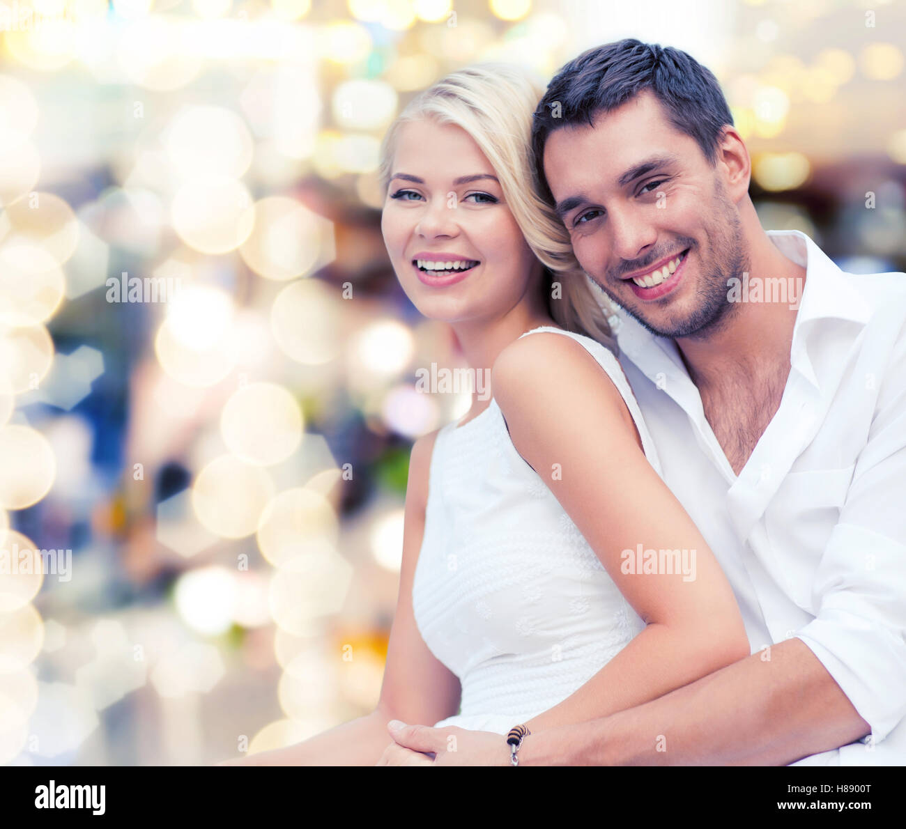 happy couple having fun over lights background Stock Photo - Alamy