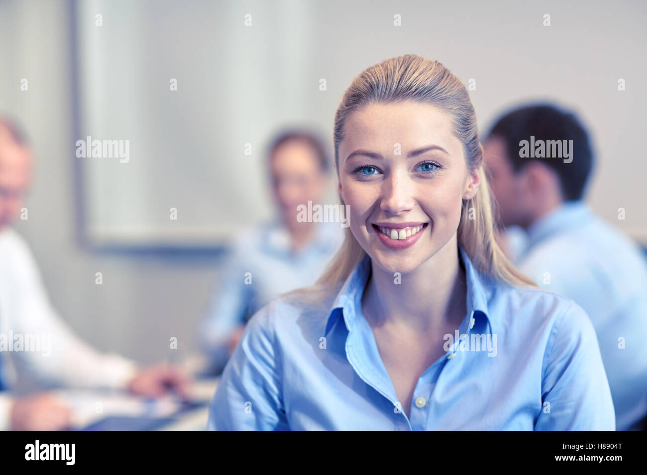 group of smiling businesspeople meeting in office Stock Photo - Alamy