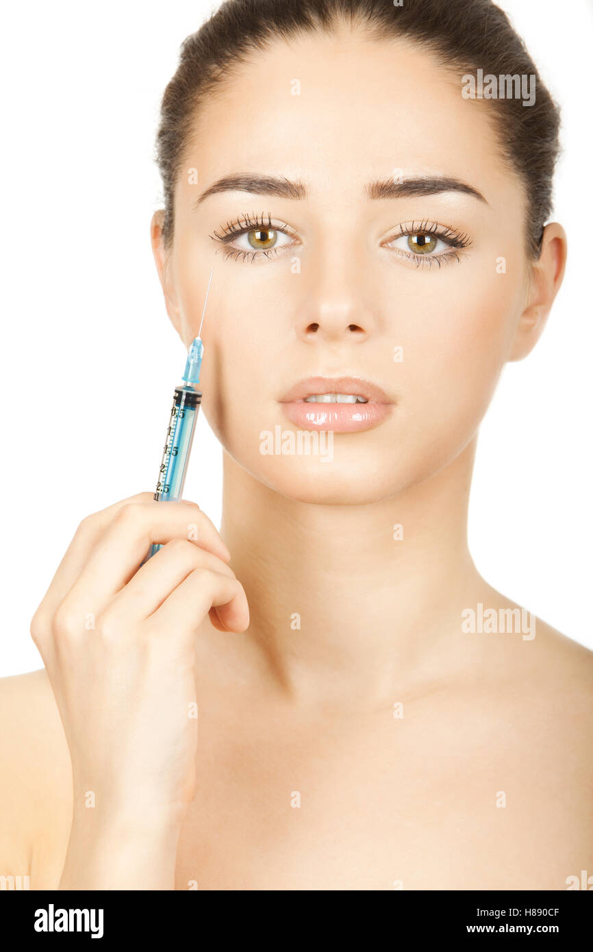 young brunette woman holding syringe Stock Photo - Alamy