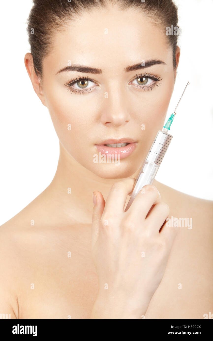 Young brunette woman holding syringe Stock Photo - Alamy