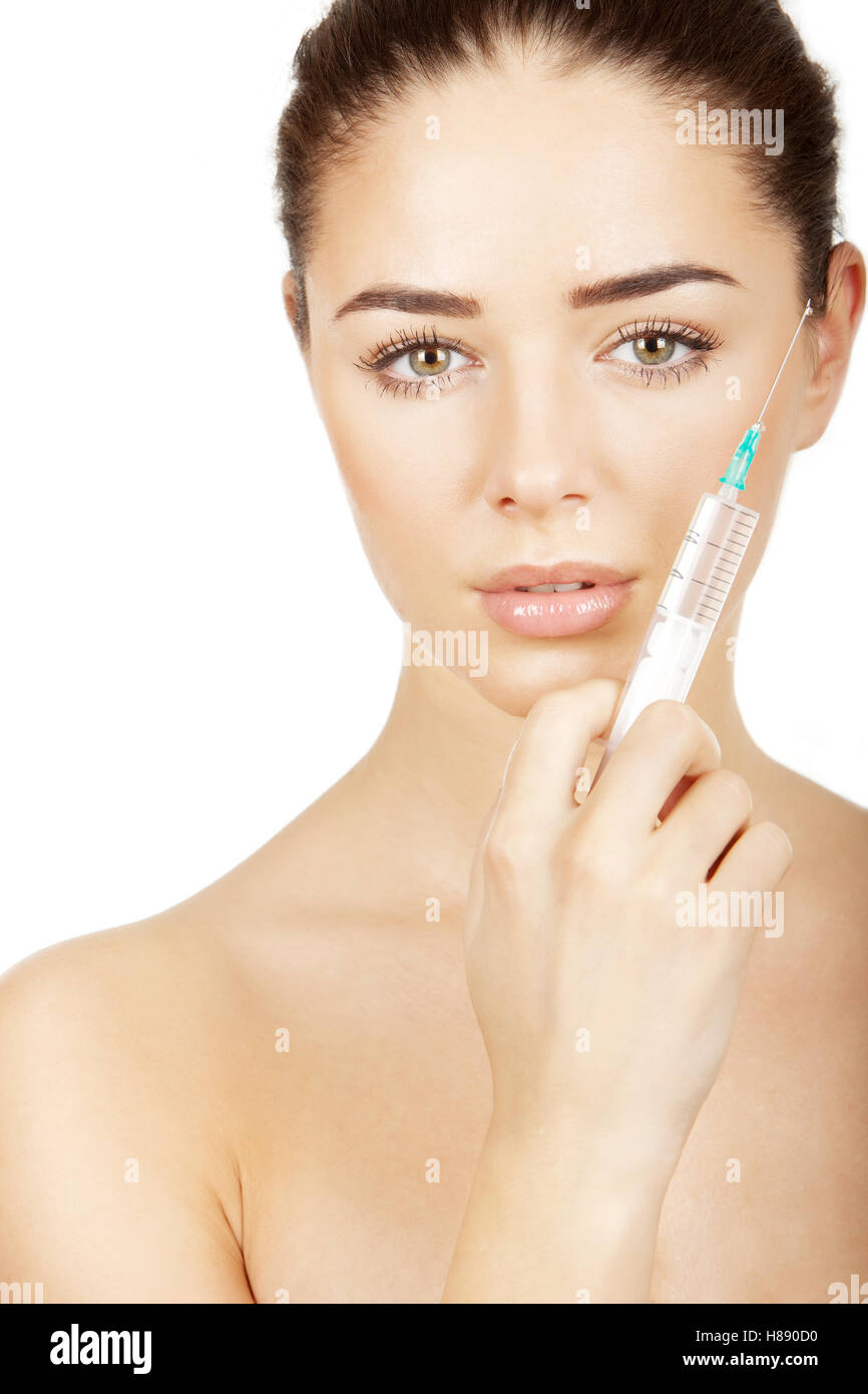 Young brunette woman holding syringe Stock Photo - Alamy