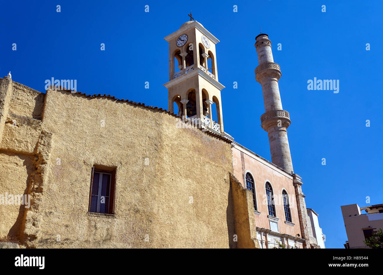 Orthodox church with a bell tower and minaret in the town of Chania ...