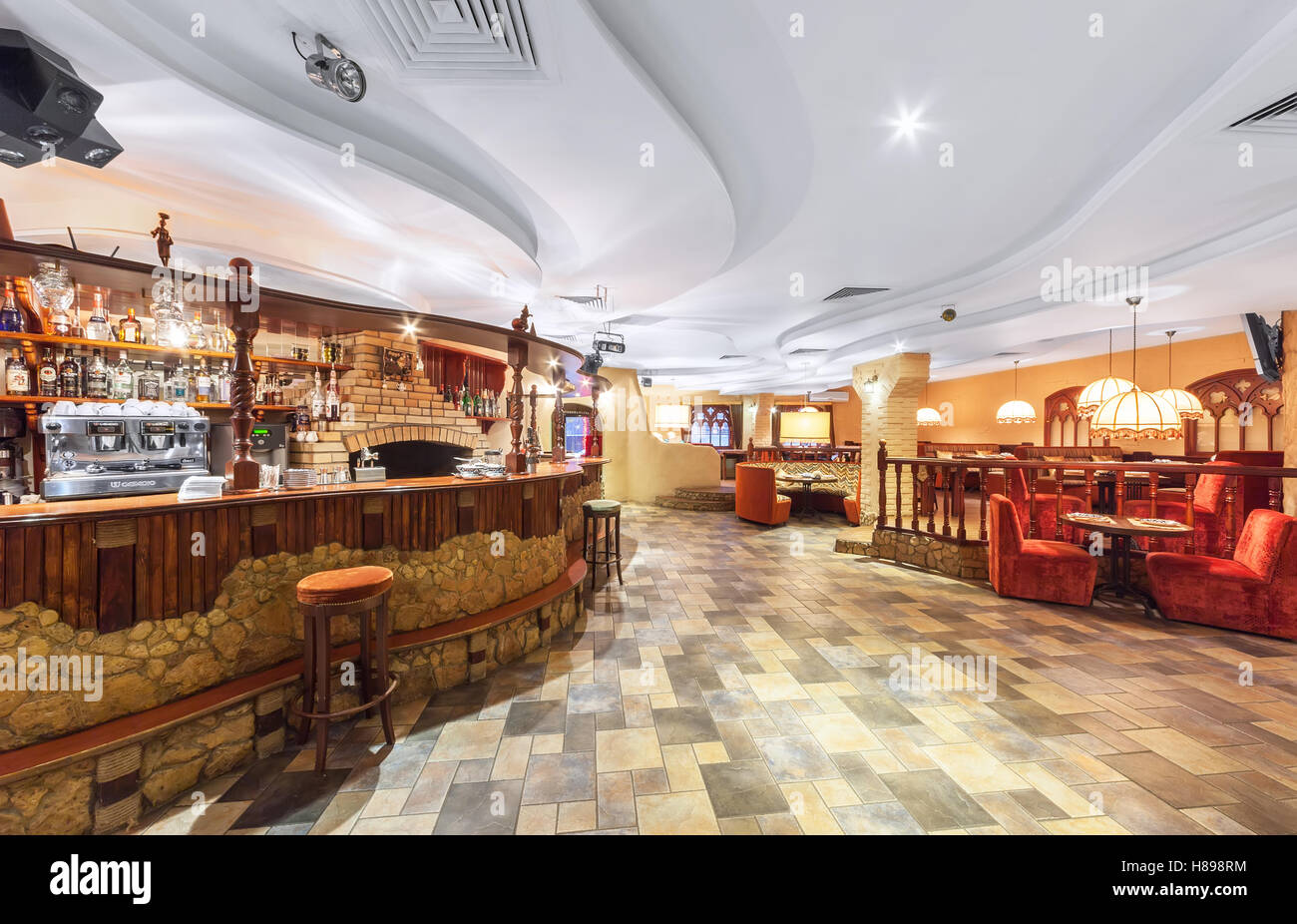Eastern interior of the uzbek restaurant. Bar of stone and wood. View ...