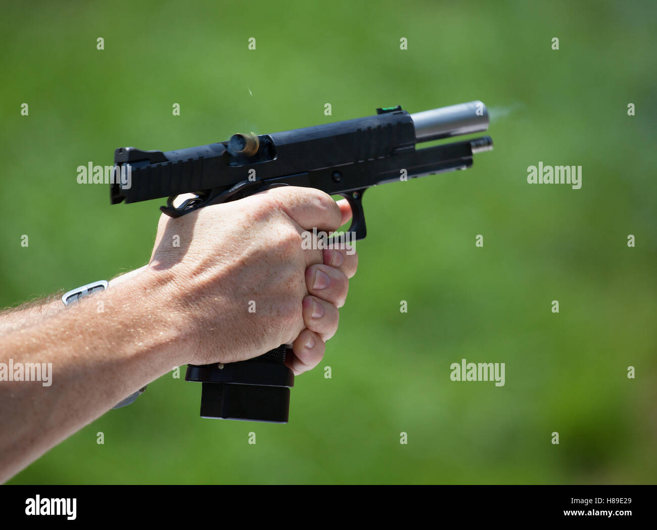Semi automatic handgun that has ejected an empty shell Stock Photo - Alamy
