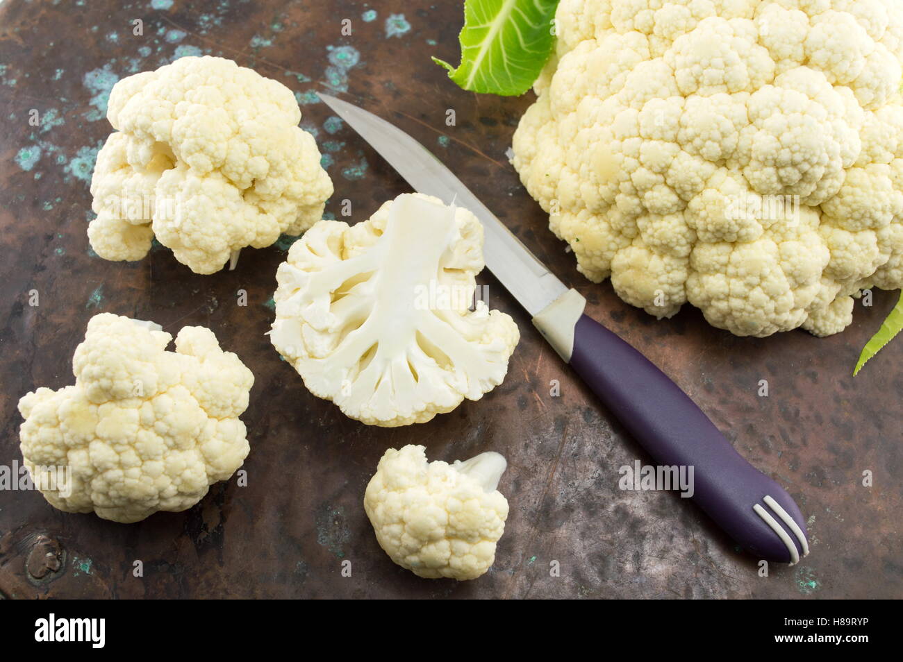 Raw cauliflower sliced on a wooden table. Healthy eating Stock Photo ...