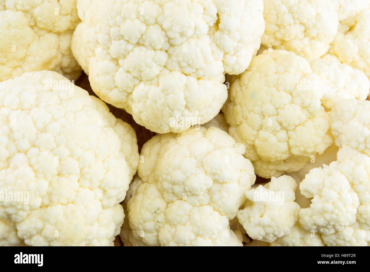 Raw cauliflower on a pile forming background Healthy eating abstract ...