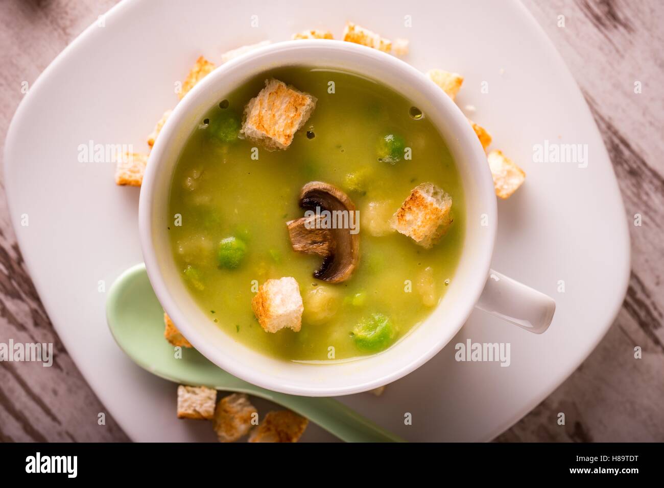 Horizontal photo with top view on split pea soup. Green soup in white ...