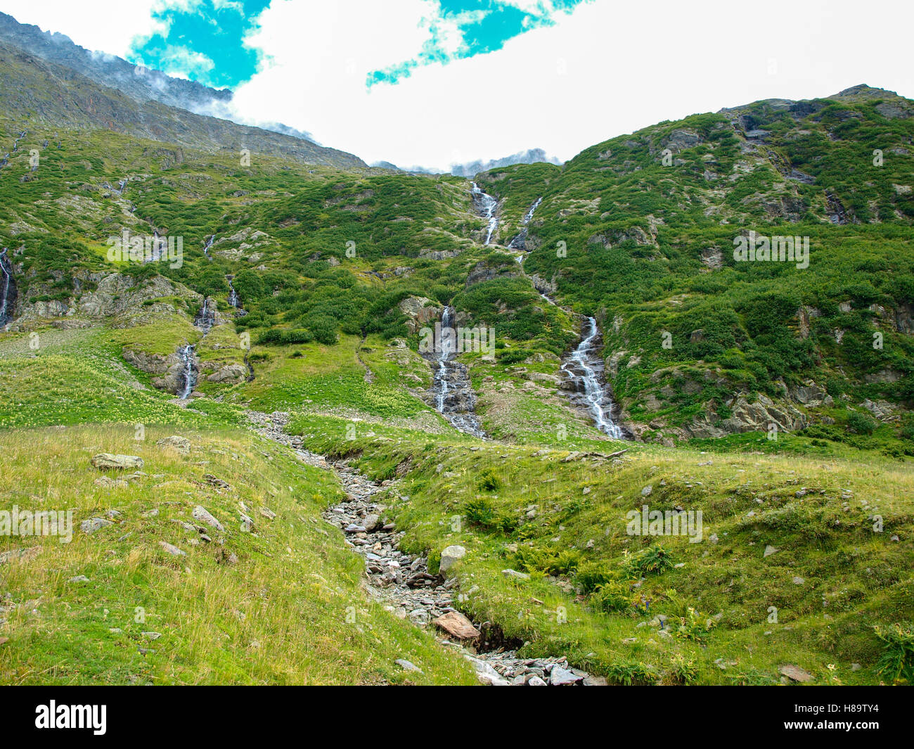 mountain rivers and stream flowing from a glacier, Switzerland alps ...