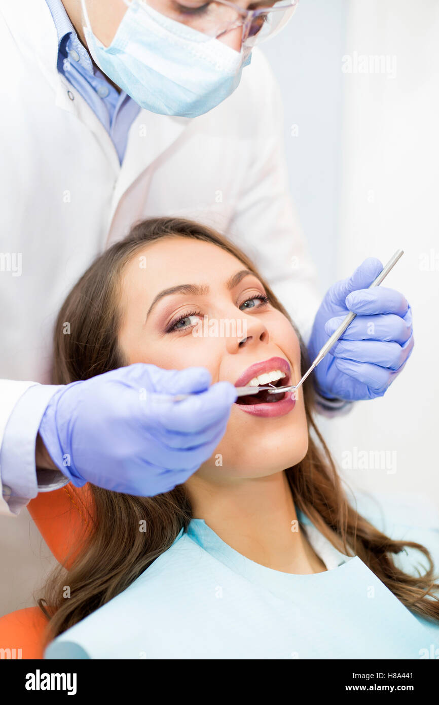 Dentist examining patient teeth treatment hi-res stock photography and ...