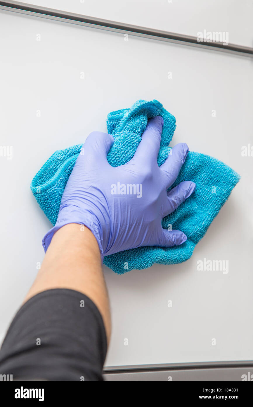 Hand with glove clean cloth surface Stock Photo - Alamy