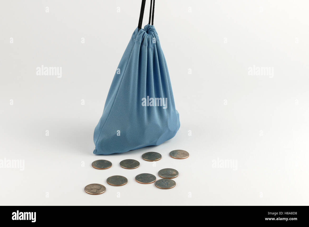 Bag full of coins isolated on white background Stock Photo - Alamy